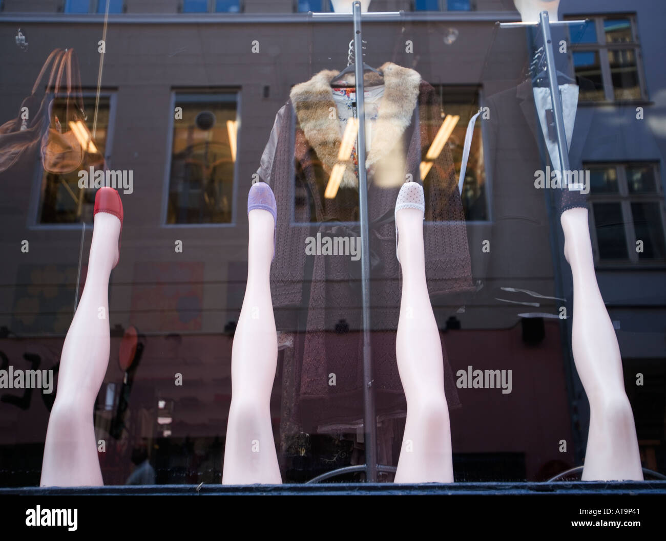 Shop window display of four dummy legs each wearing a different ...