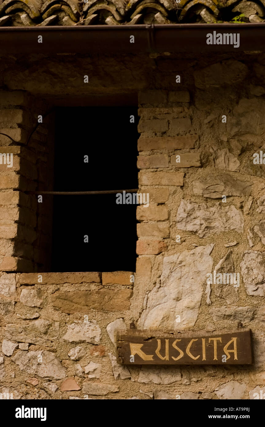 Exit sign Uscita in Italian that indicates a window on a wall Stock ...