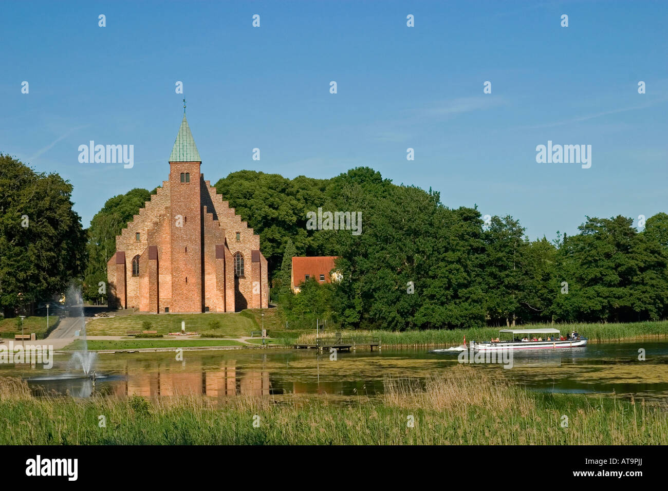 A tourist tour boat has departed from its check out point at Maribo ...