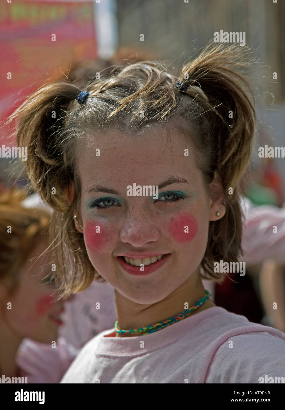 Attractive young perform with freckles and red makeup on cheeks poses ...