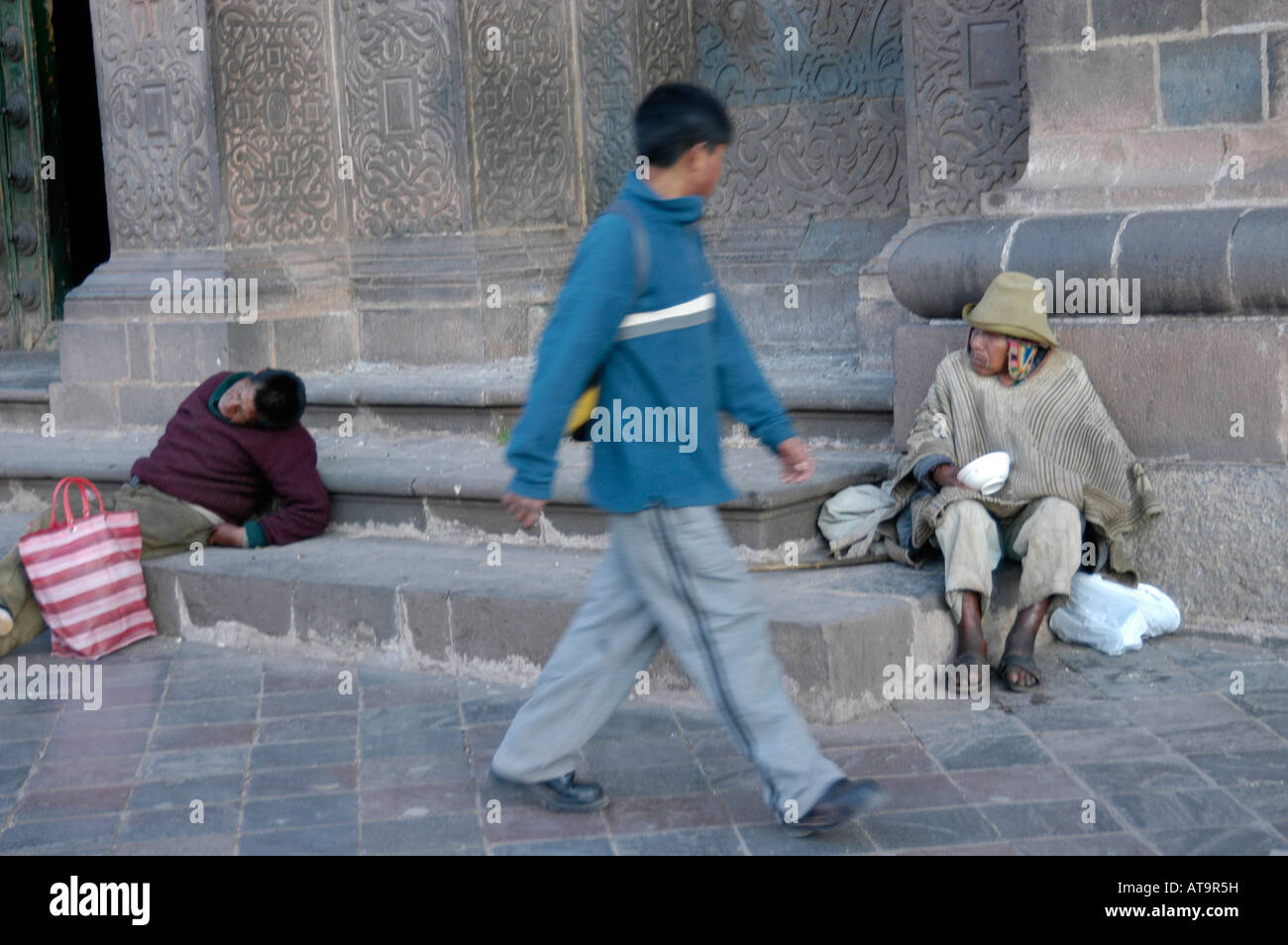 Poor people on the step of the colonial cathedral on Plaza de Armas ...