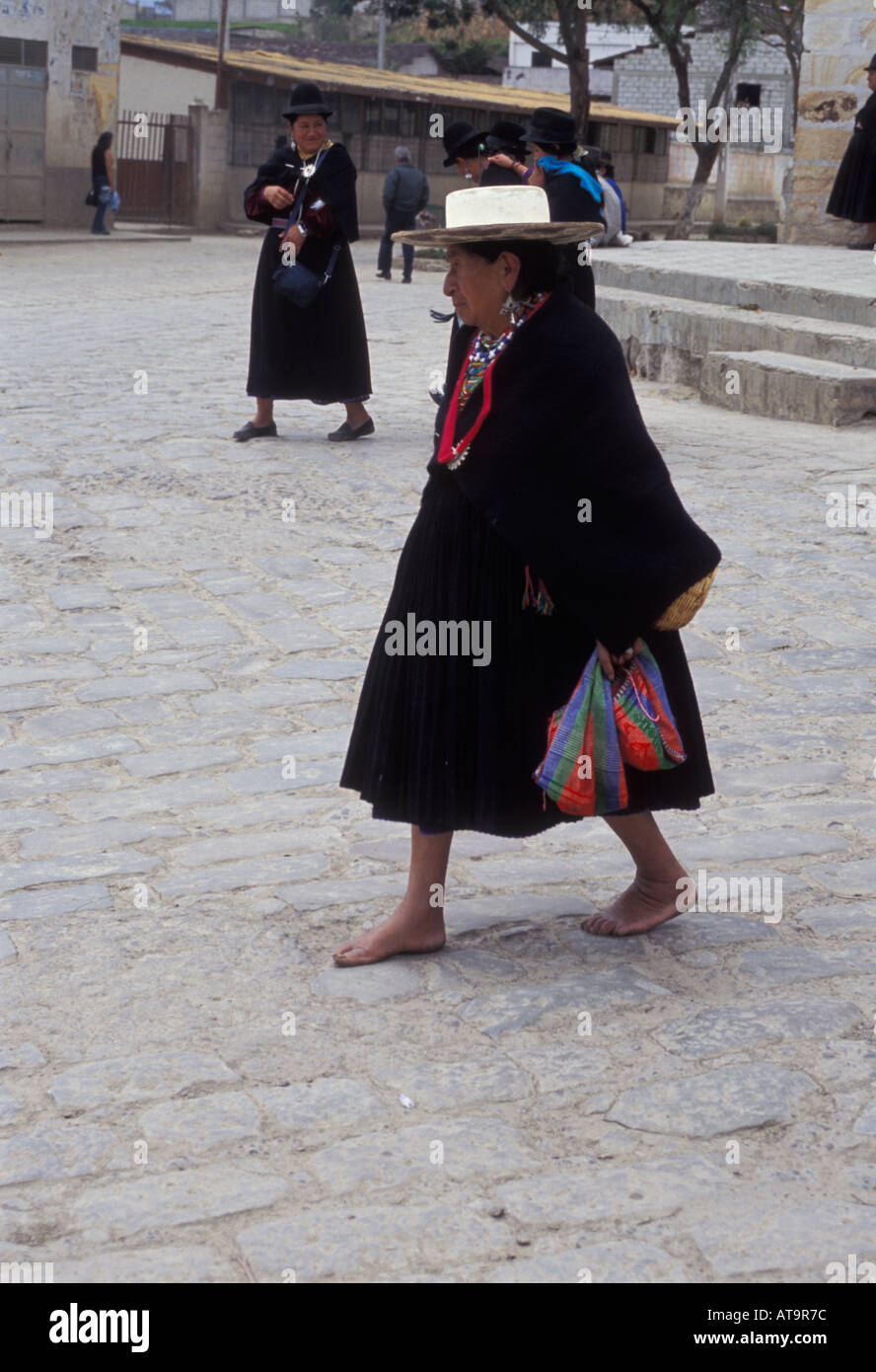 Indigenous old woman walking barefoot after Sunday mass in typical ...
