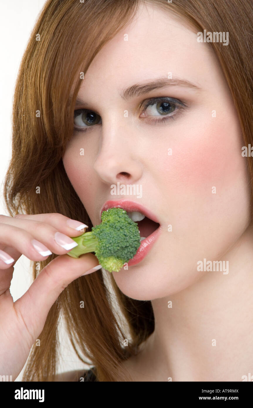 woman eating broccoli Stock Photo - Alamy