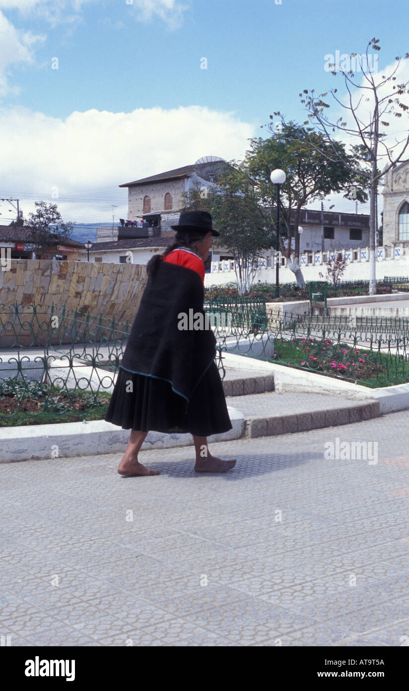 Indigenous woman in typical black clothes walking barefoot in the main ...