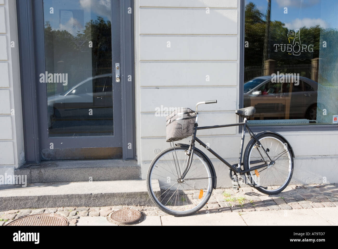 Copenhagen Denmark Bicycle leaning against shop with Tuborg beer sign ...