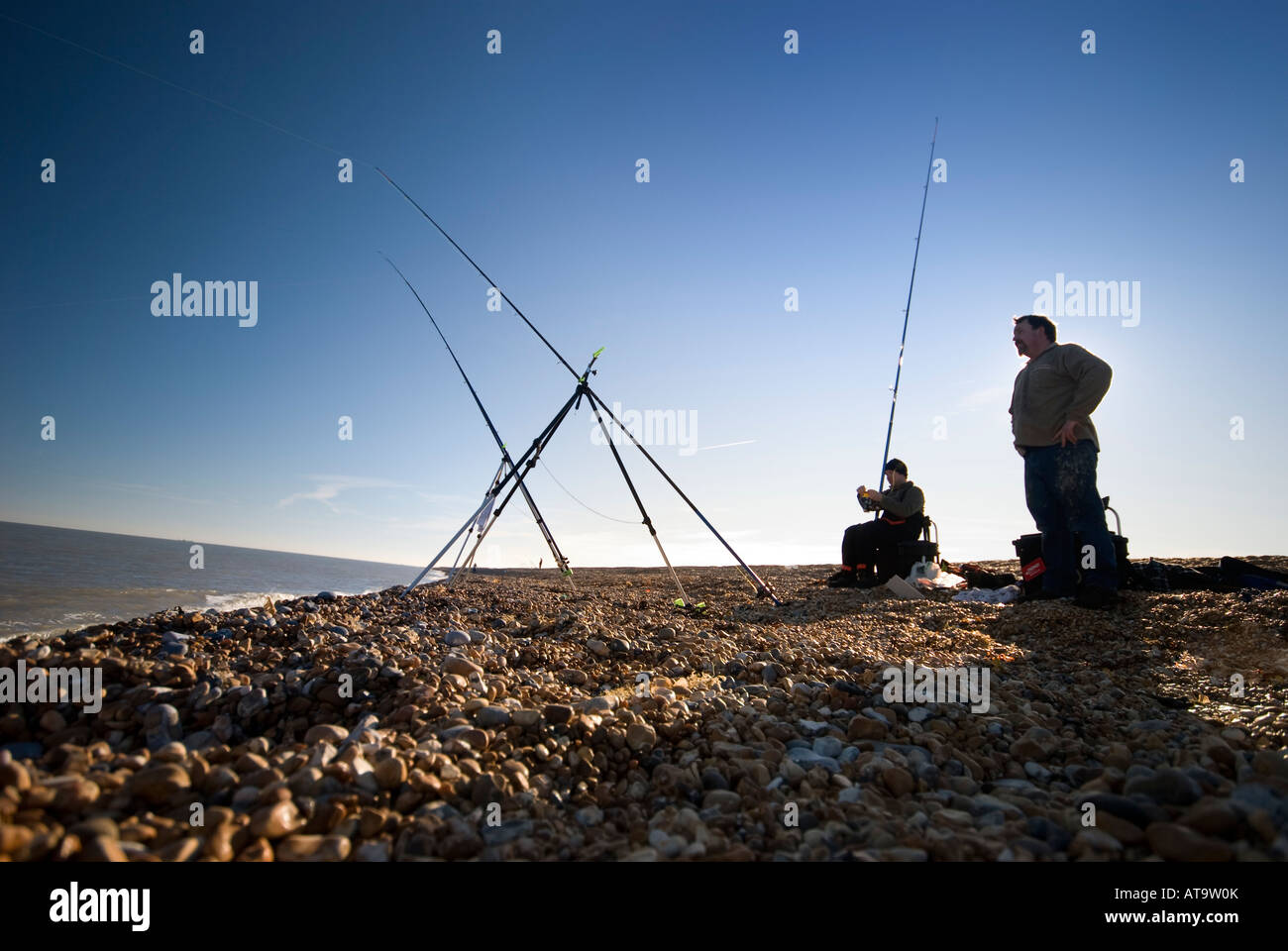 Silhouette two men sea fishing hi-res stock photography and images - Alamy