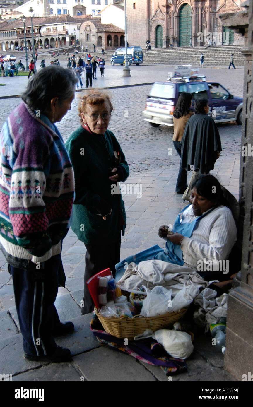 Poor woman on the step of the colonial cathedral on Plaza de Armas ...