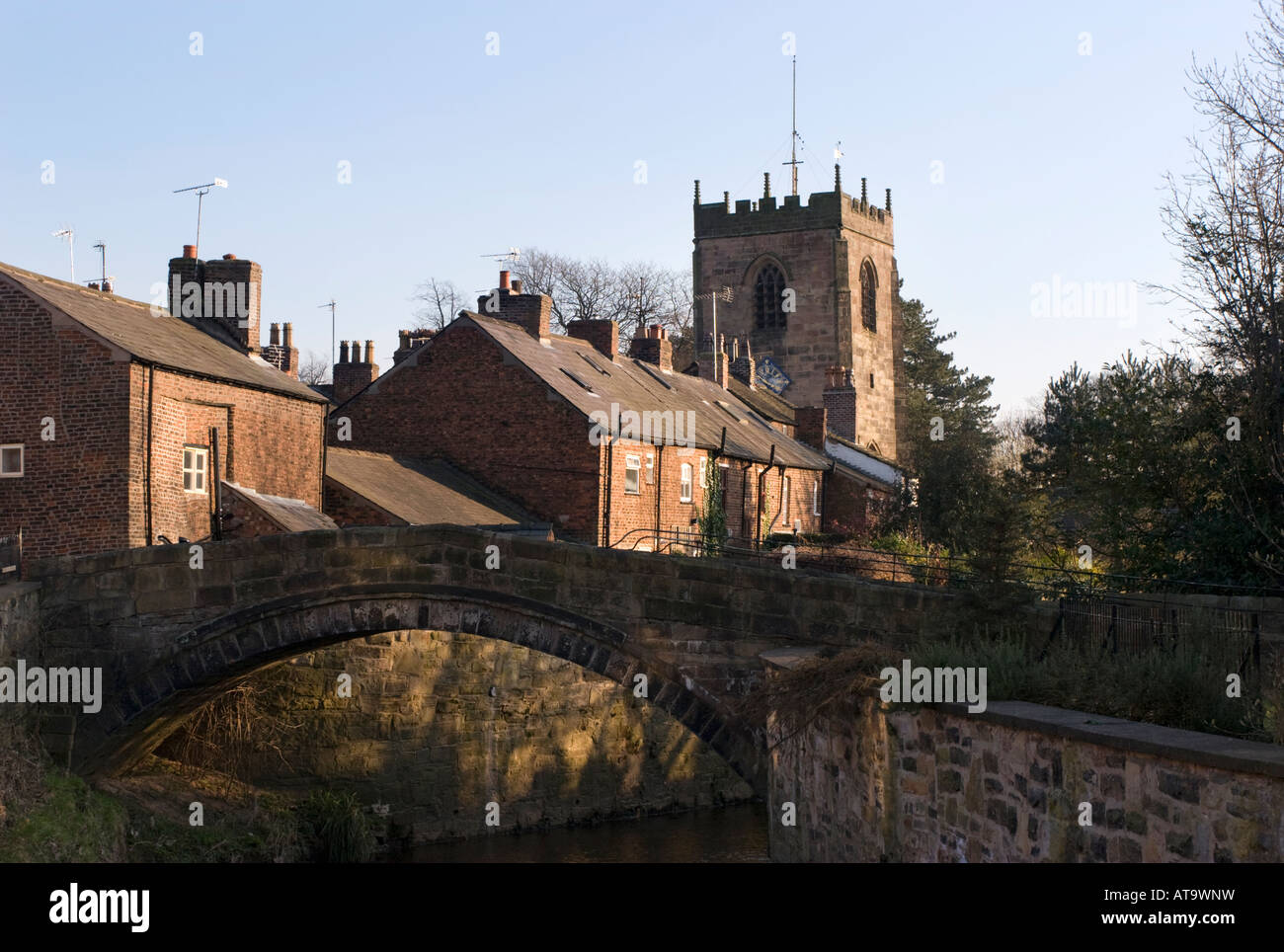 Packhorse bridge over the River Yarrow at Croston in Lancashire with St ...