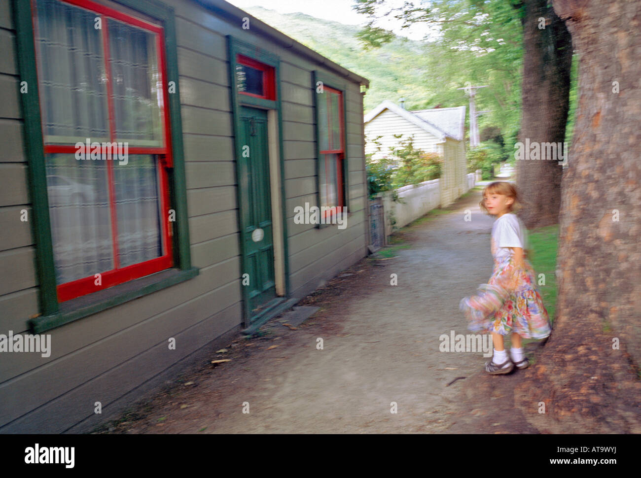 Young girl on a sidewalk in Wanaka New Zealand Stock Photo - Alamy