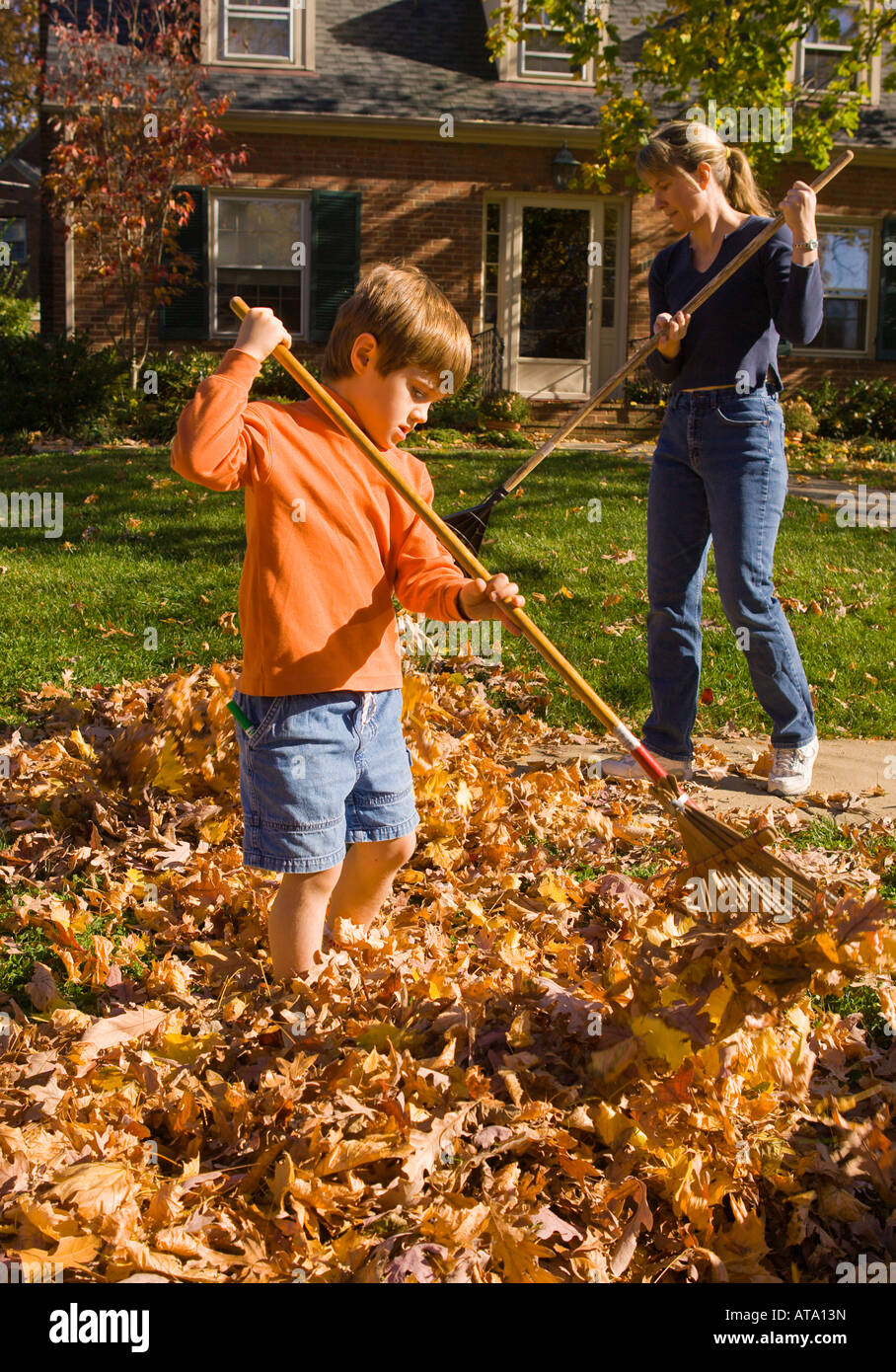 Children raking leaves hi-res stock photography and images - Alamy
