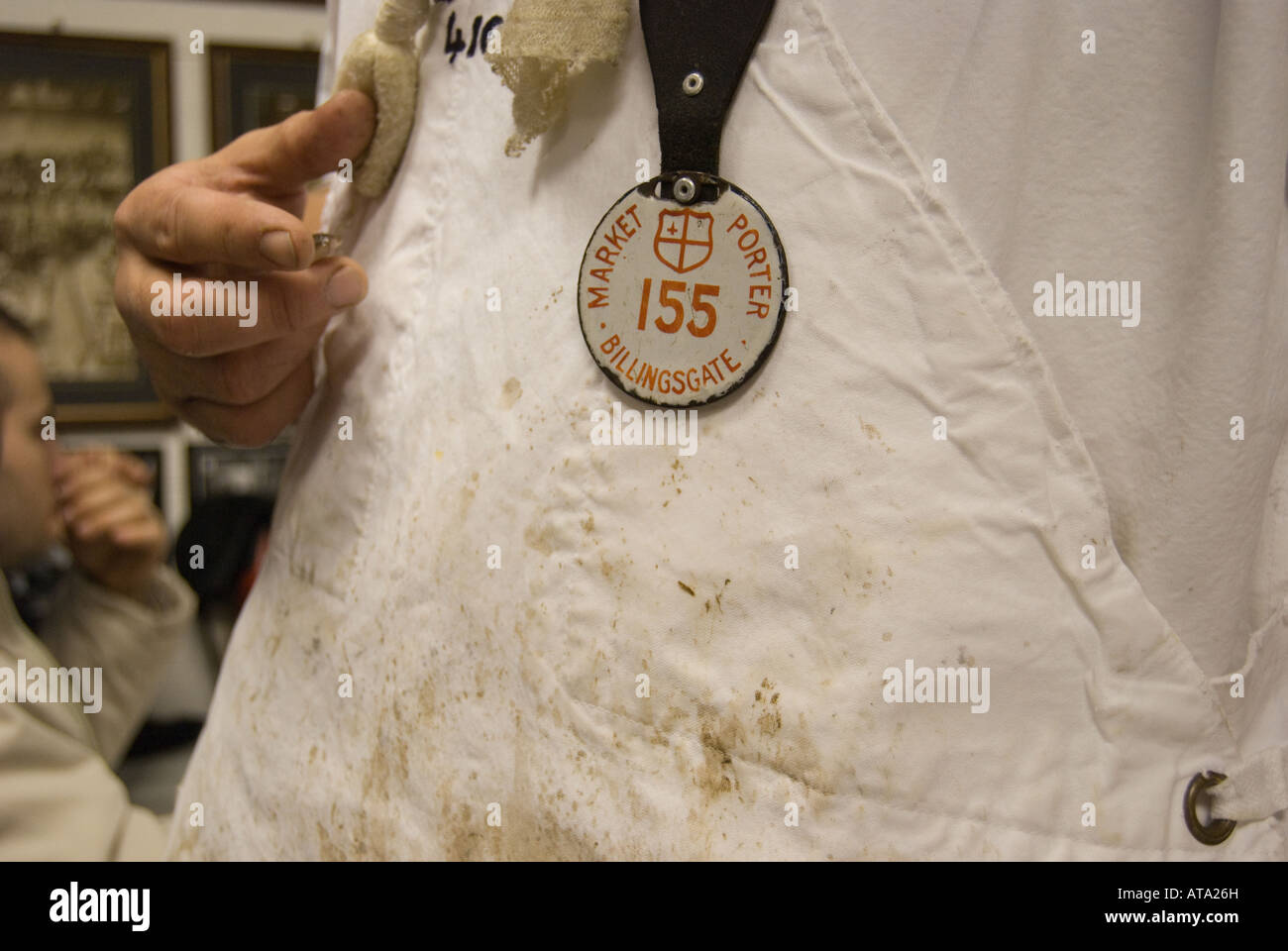 Porter pointing to his porter's badge at Billingsgate Market Stock ...