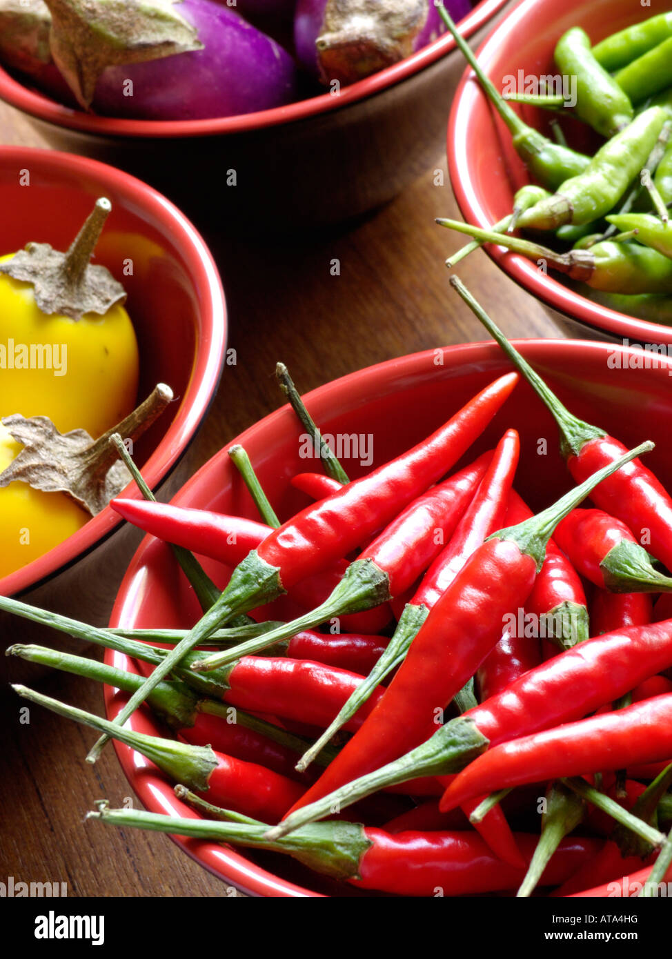 Chili pepper (Capsicum) and aubergine (Solanum melongena Stock Photo ...
