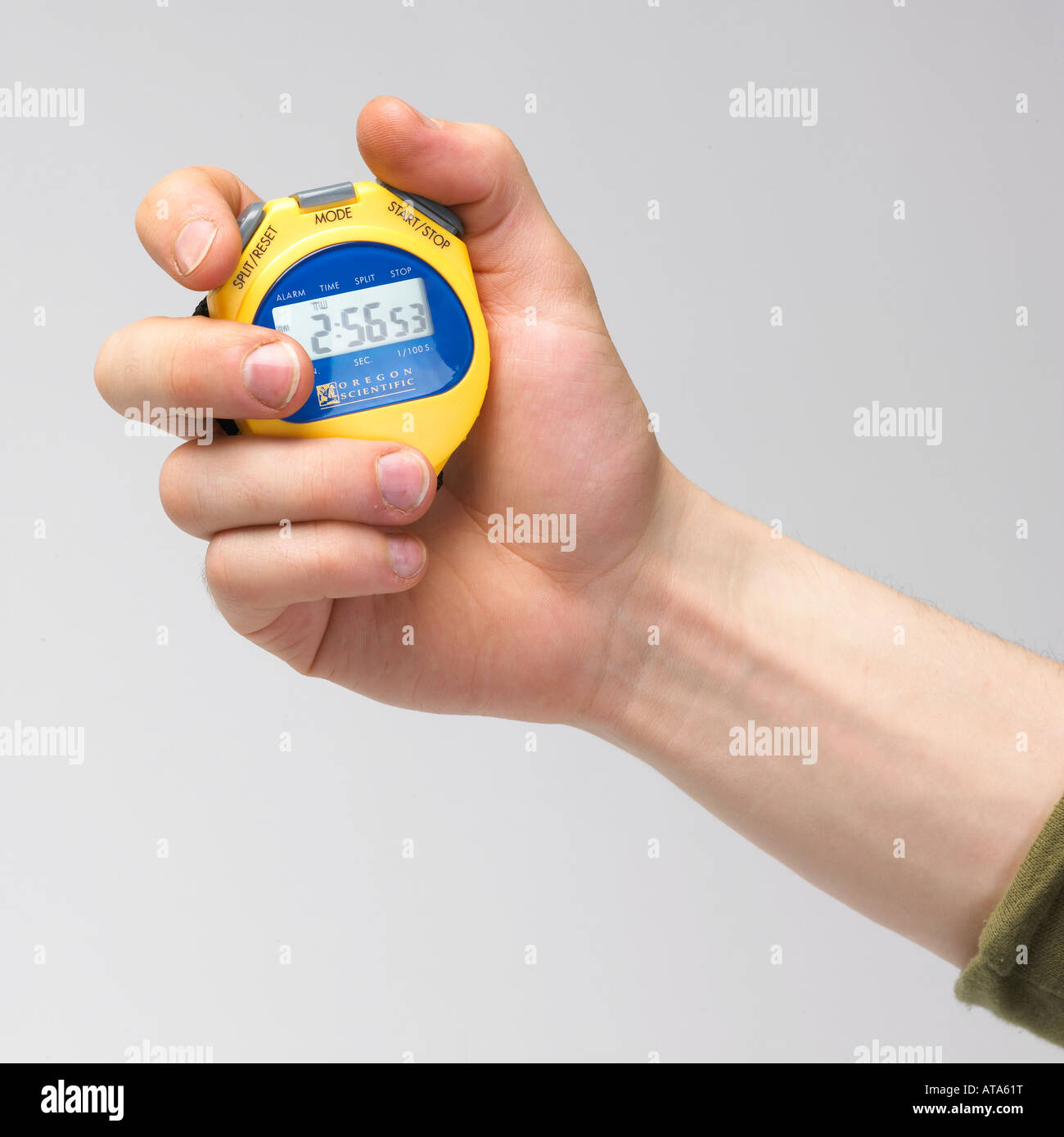 mans hand holding a yellow stop watch Stock Photo - Alamy