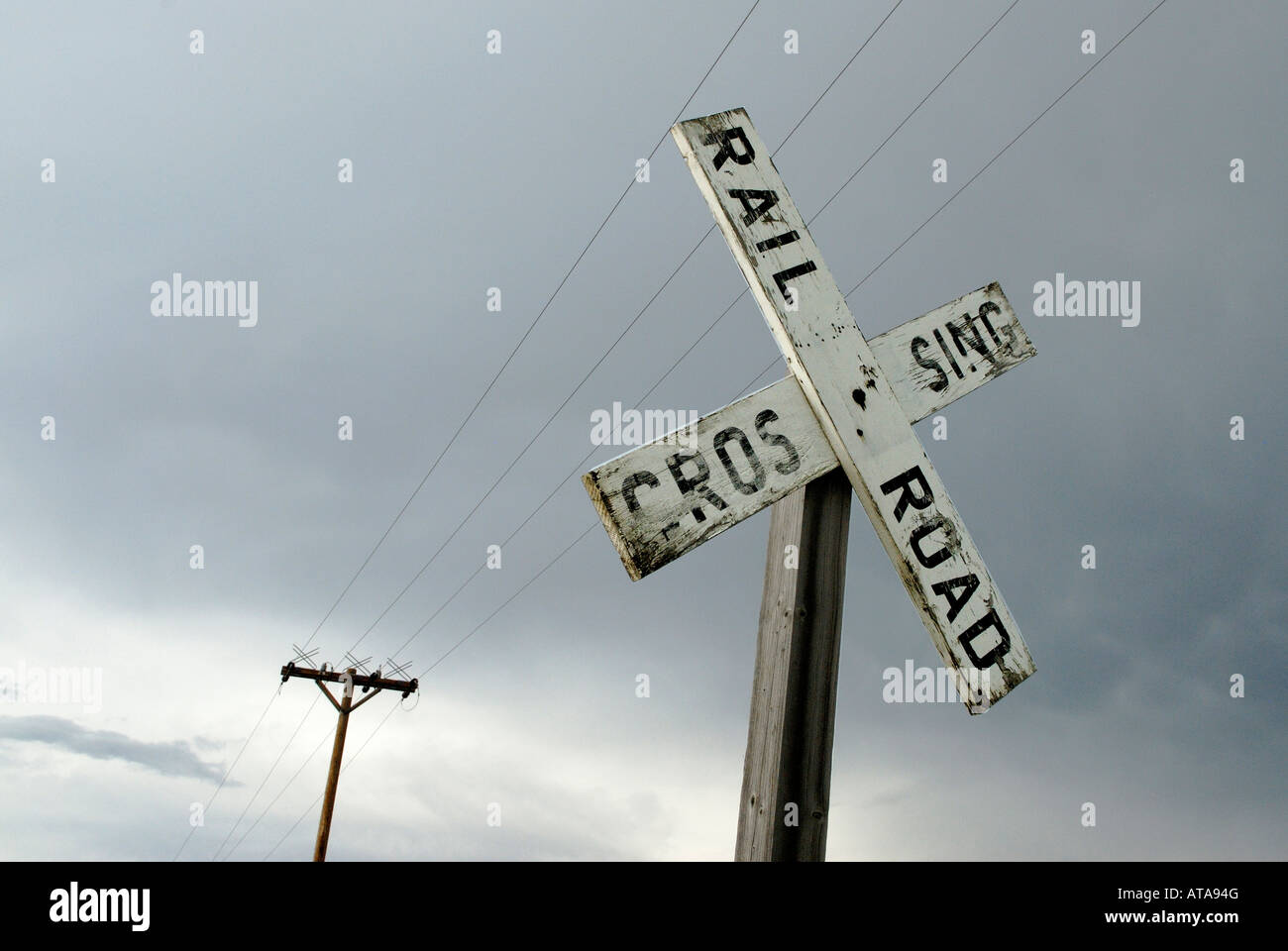 An old wooden railroad crossing sign juxtaposed with a high wire Stock ...