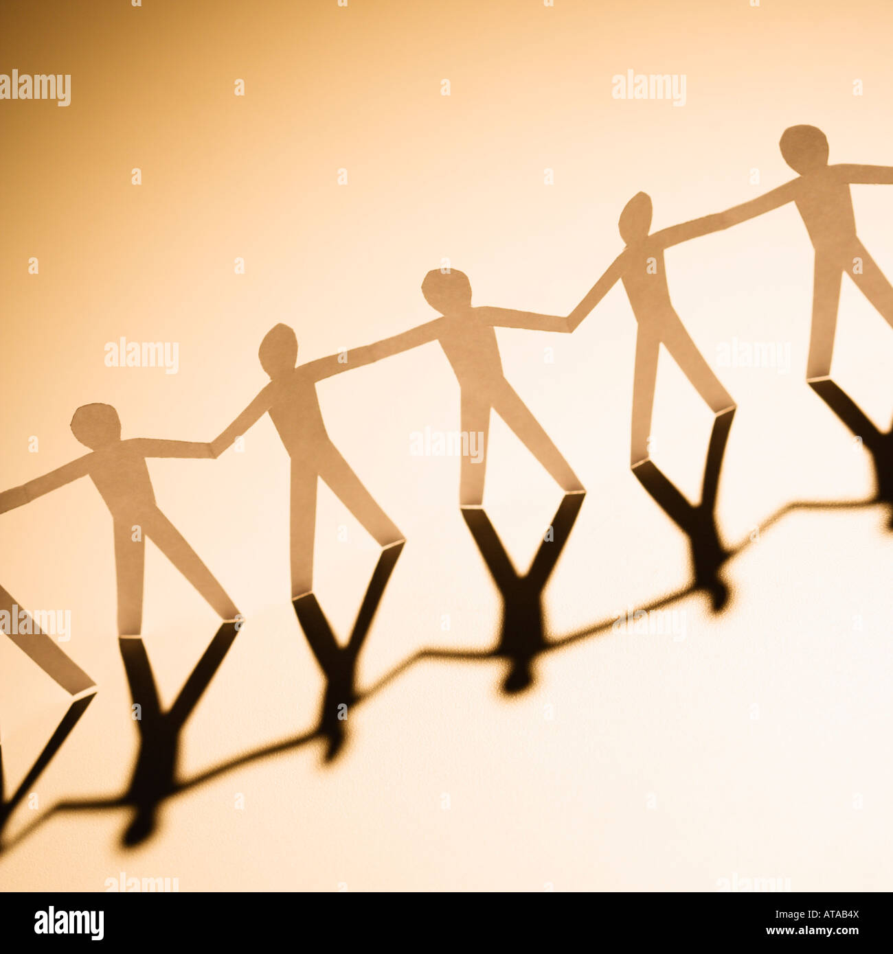 Cutout paper men standing holding hands Stock Photo - Alamy