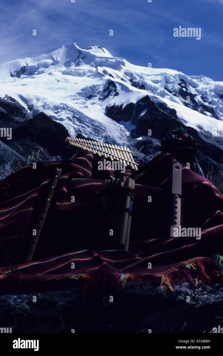 Traditional Inca indian panpipes and instruments against the snow ...