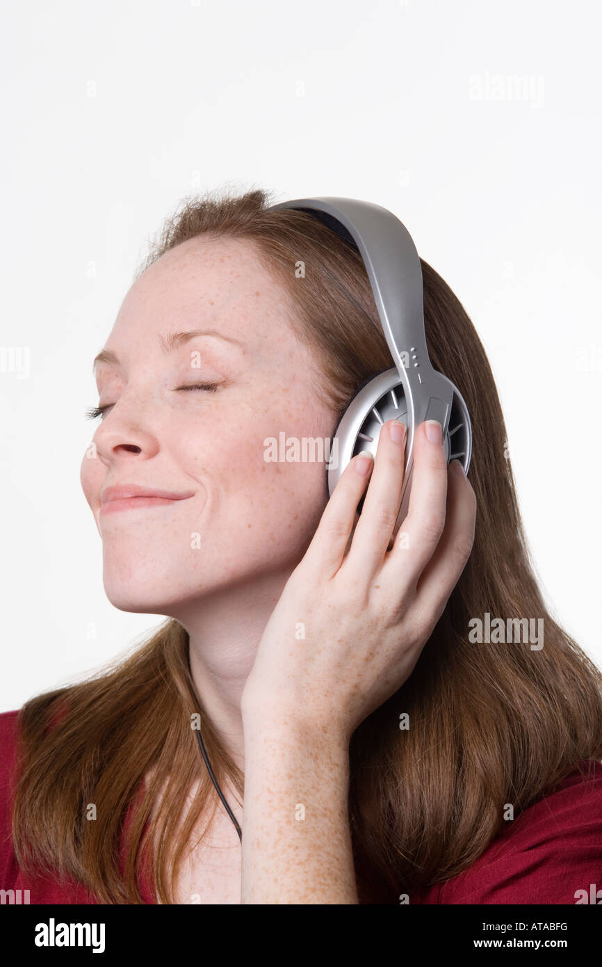 Young woman listening to headphones Stock Photo - Alamy