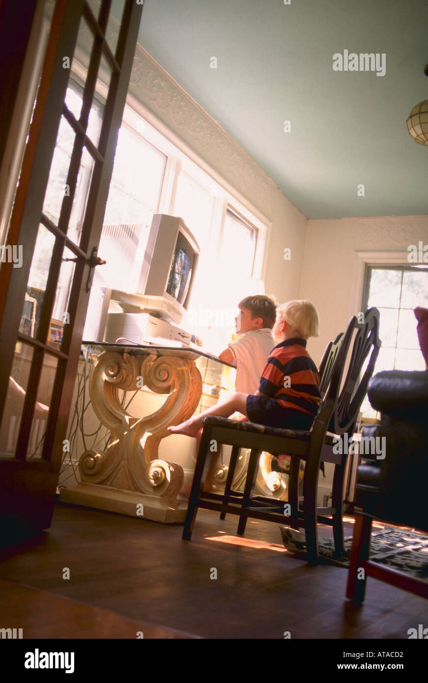 Two young boys using computer at home Stock Photo - Alamy