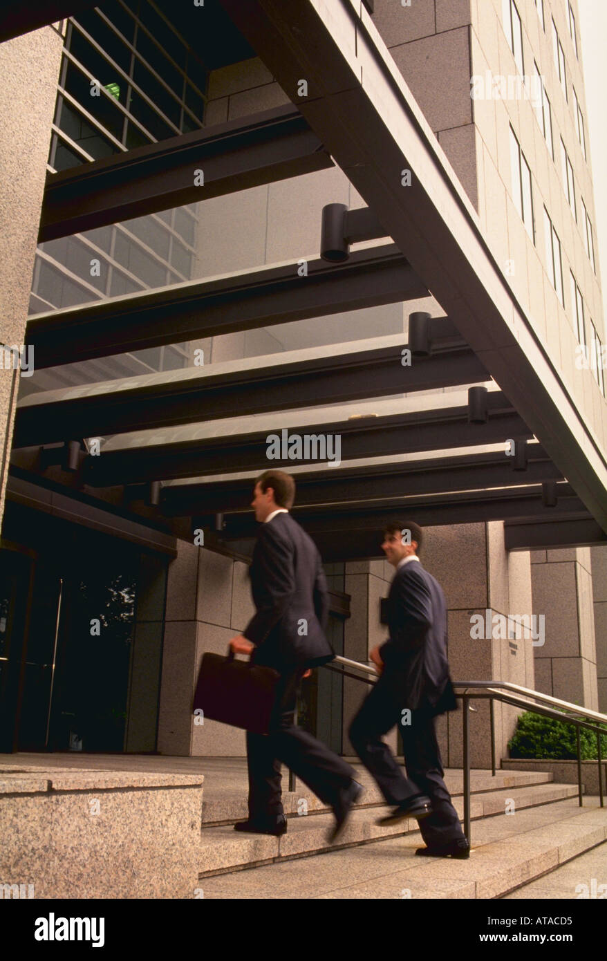 Two business people walking up stairs hi-res stock photography and ...