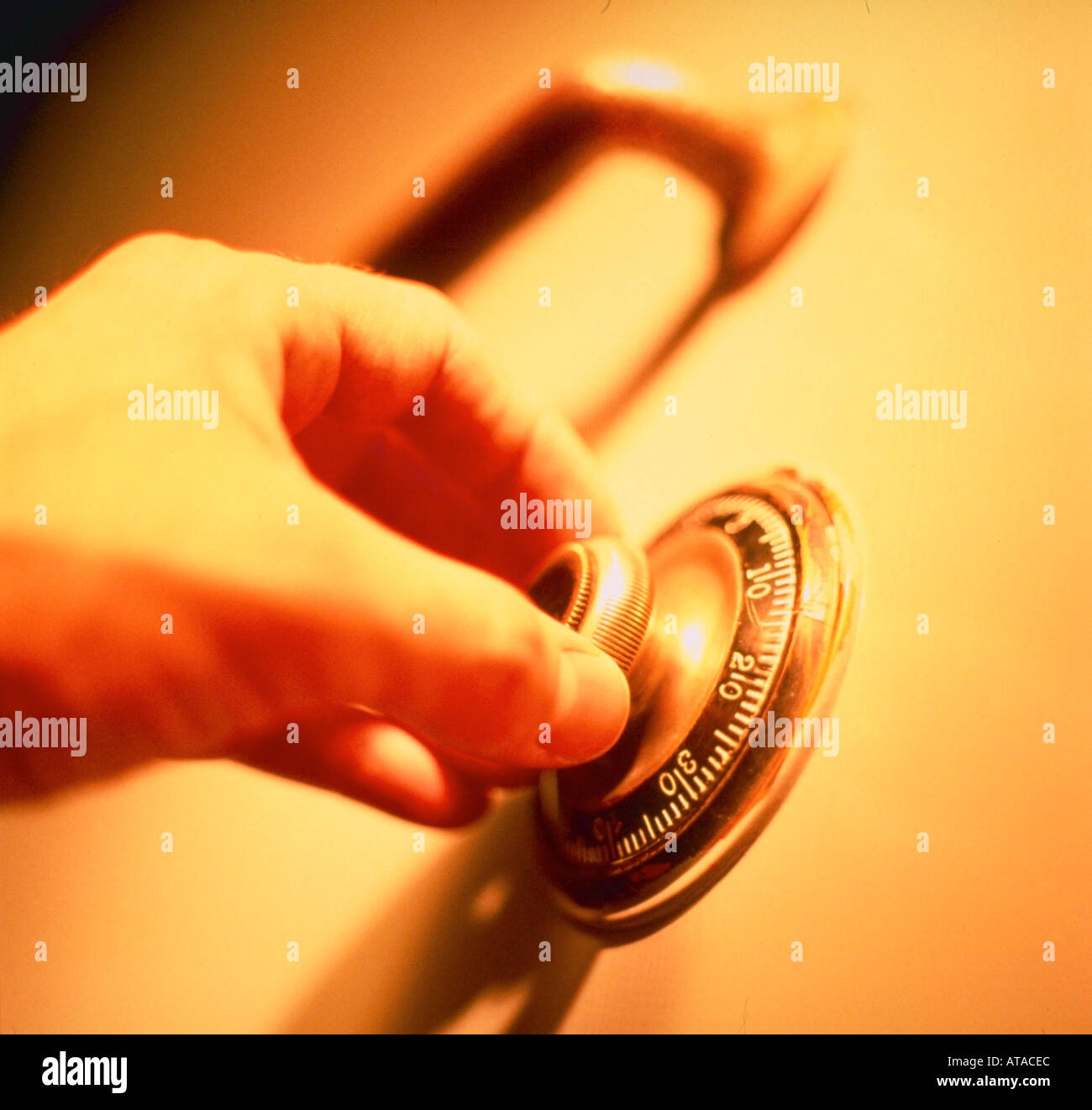 Man hand turning safe combination dial Stock Photo - Alamy