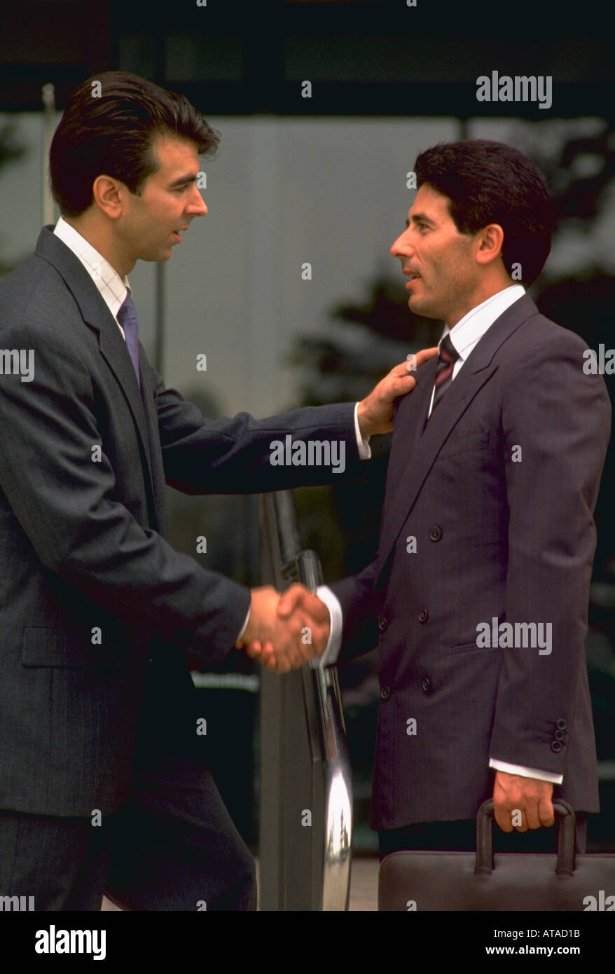 Two businessmen shaking hands outside hi-res stock photography and ...