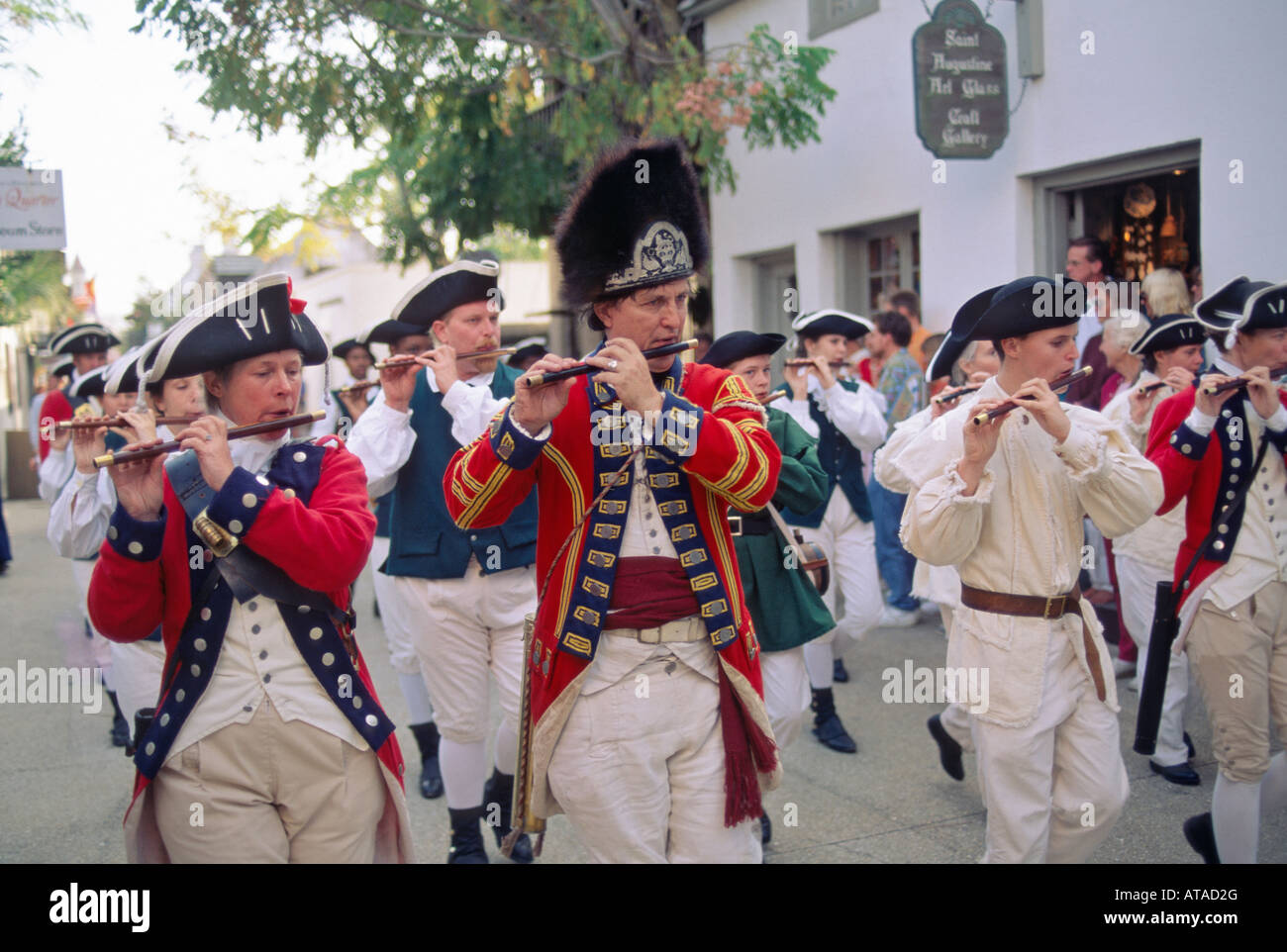 Reenactors playing flutes in a parade on a street in St Augustine ...