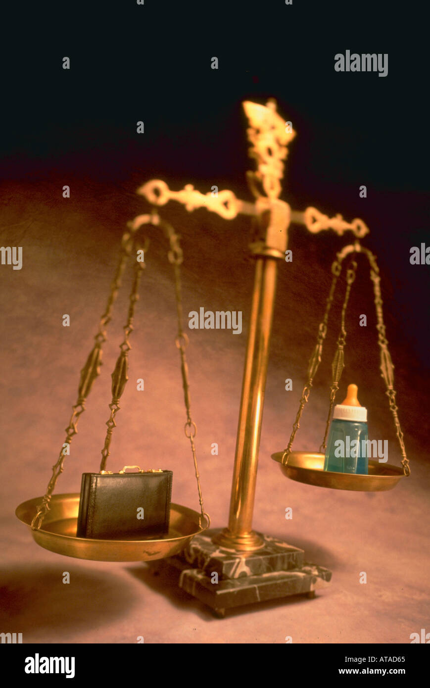 Scale balancing a briefcase and a baby bottle Balancing work and ...