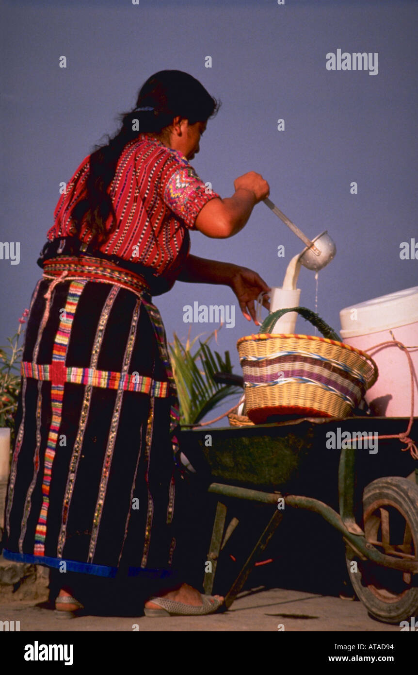 GUATEMALA WOMAN VENDOR SELLING MILK FROM A WHEELBARROW Stock Photo - Alamy