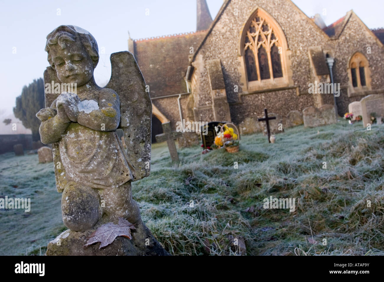 Early morning sun lights up a church and graveyard Stock Photo - Alamy