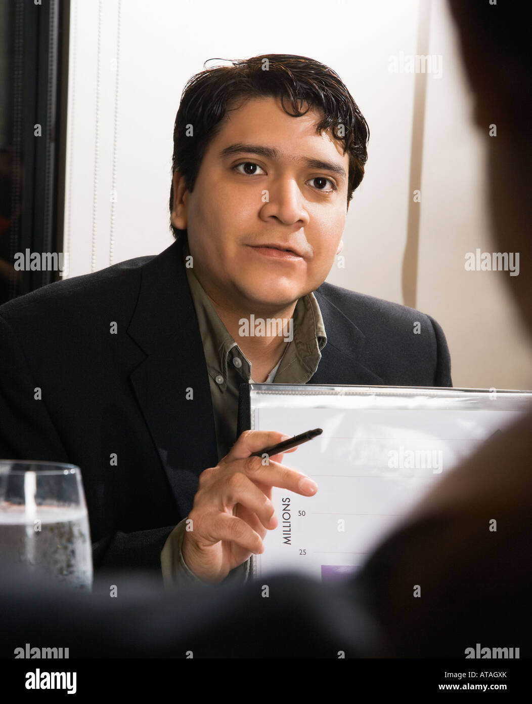 Businessman in meeting with charts Stock Photo - Alamy