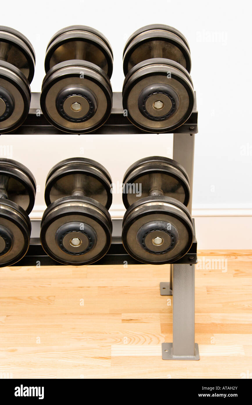 Hand weights on rack at gym Stock Photo - Alamy
