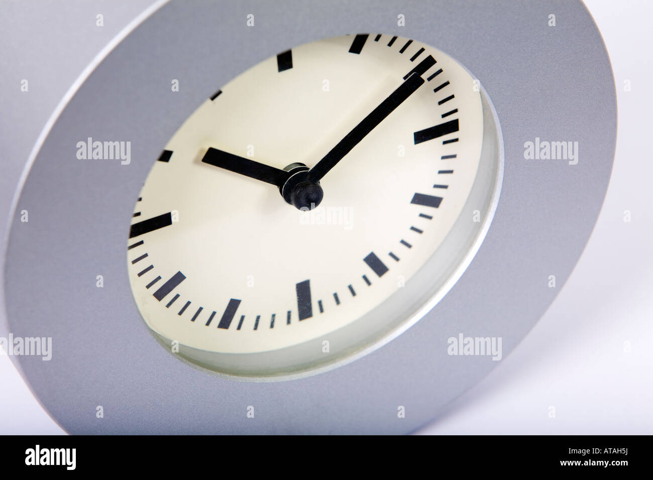 Round silver clock with hands telling ten-to-ten time Stock Photo - Alamy