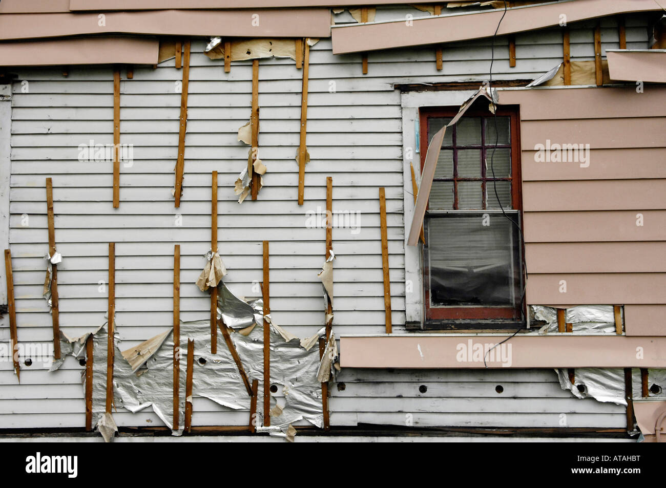 Detail of boarded-up home with missing siding Stock Photo - Alamy