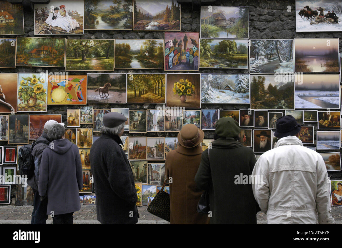 People in front of an art exhibition in the Old Town in Cracow, Poland ...