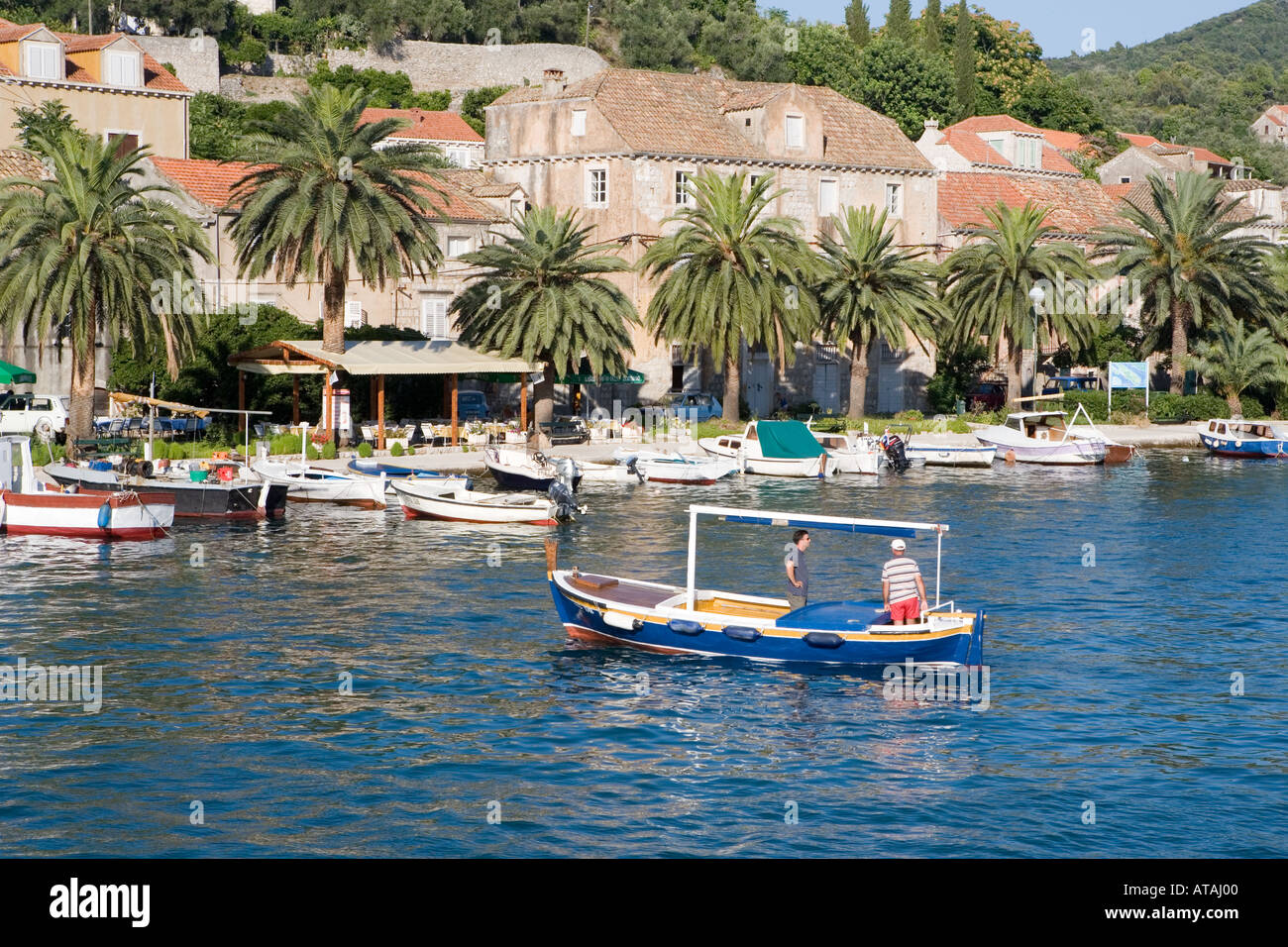 Fisherman and small boat at Sipan one of the Elafiti islands Croatia ...