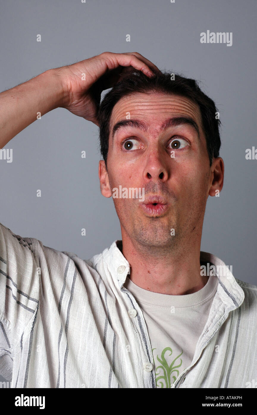 Surprised young man slightly scruffy and casually dressed Stock Photo ...