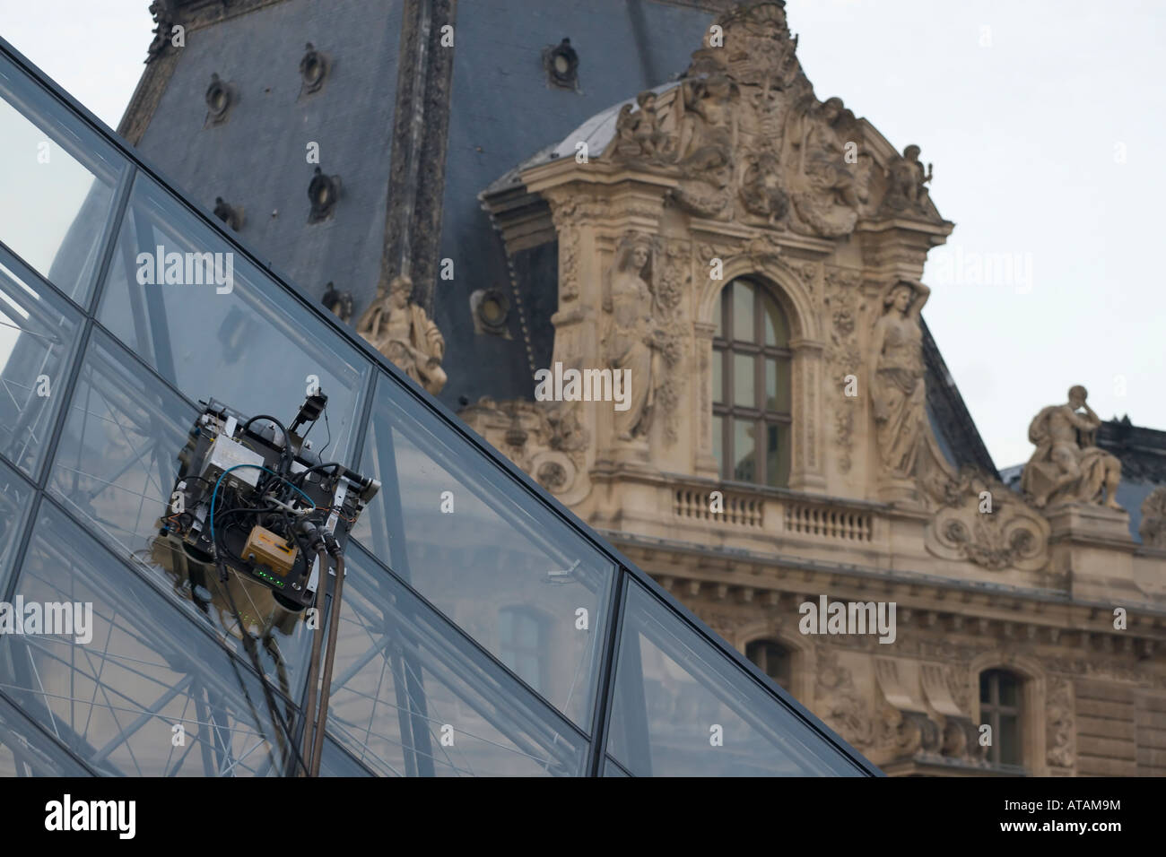 Window Cleaning machine at the Louvre Pyramid, Paris, France Stock ...