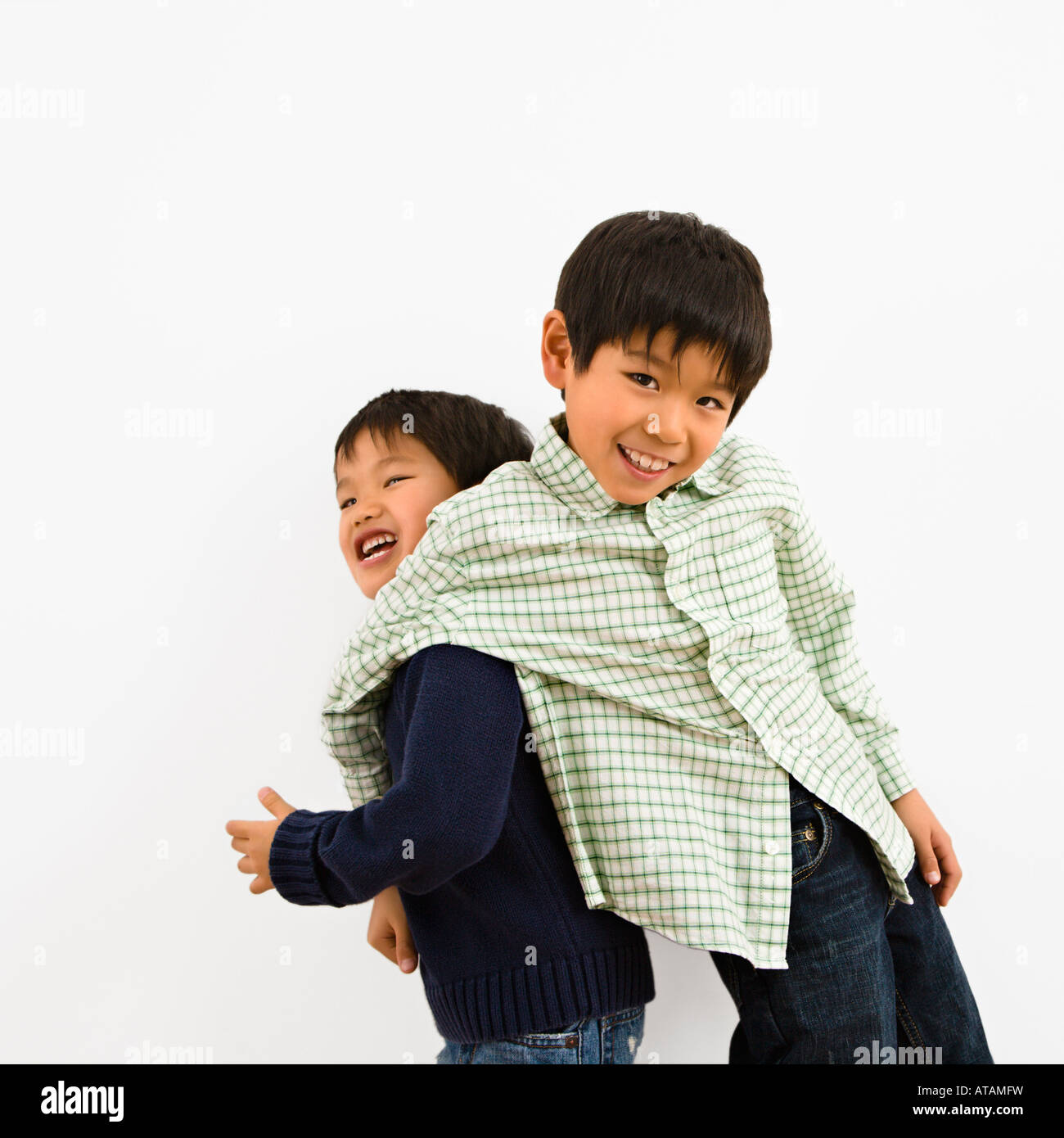 Two young Asian brothers playing and laughing Stock Photo - Alamy