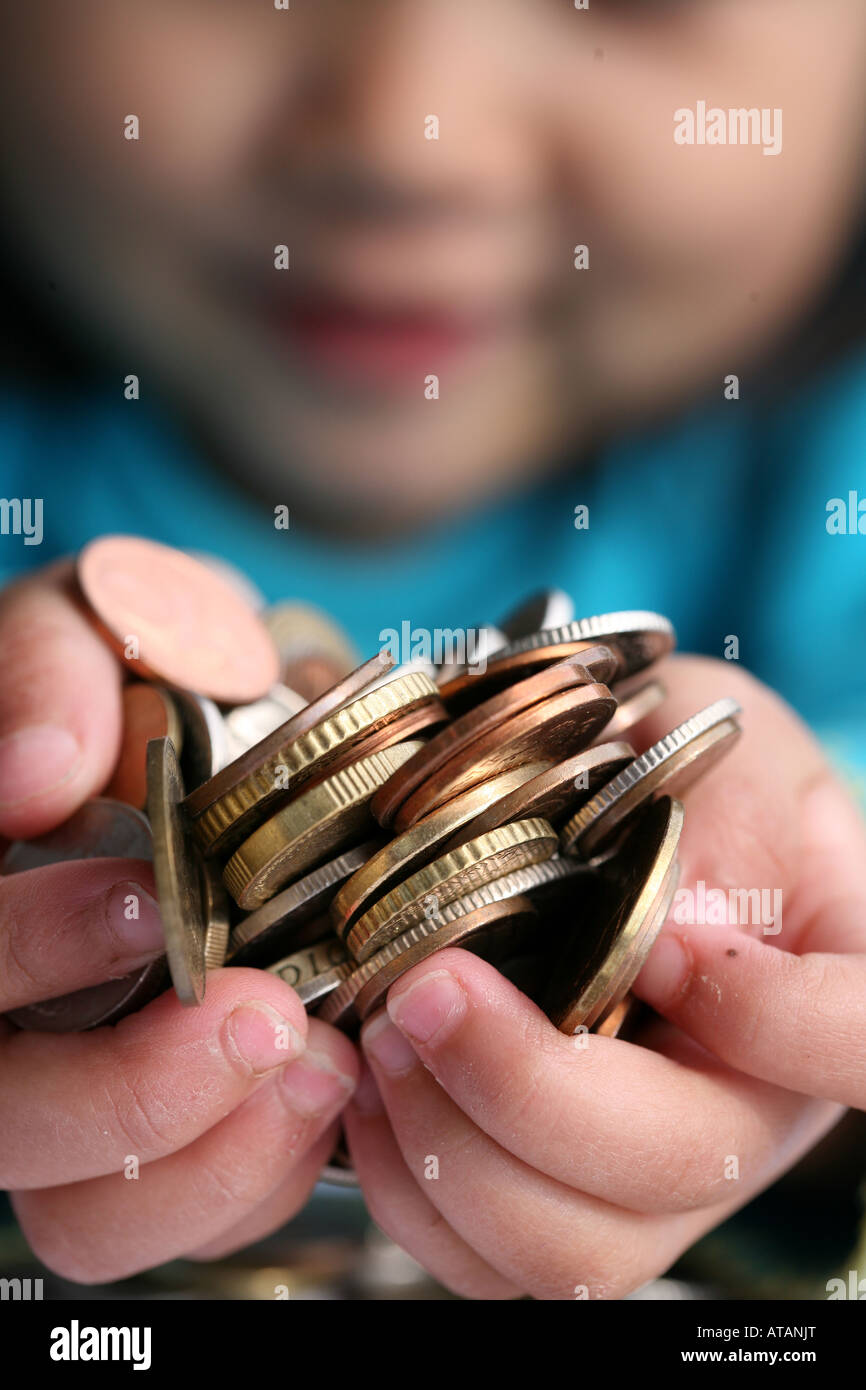 child holding money in hands Stock Photo - Alamy