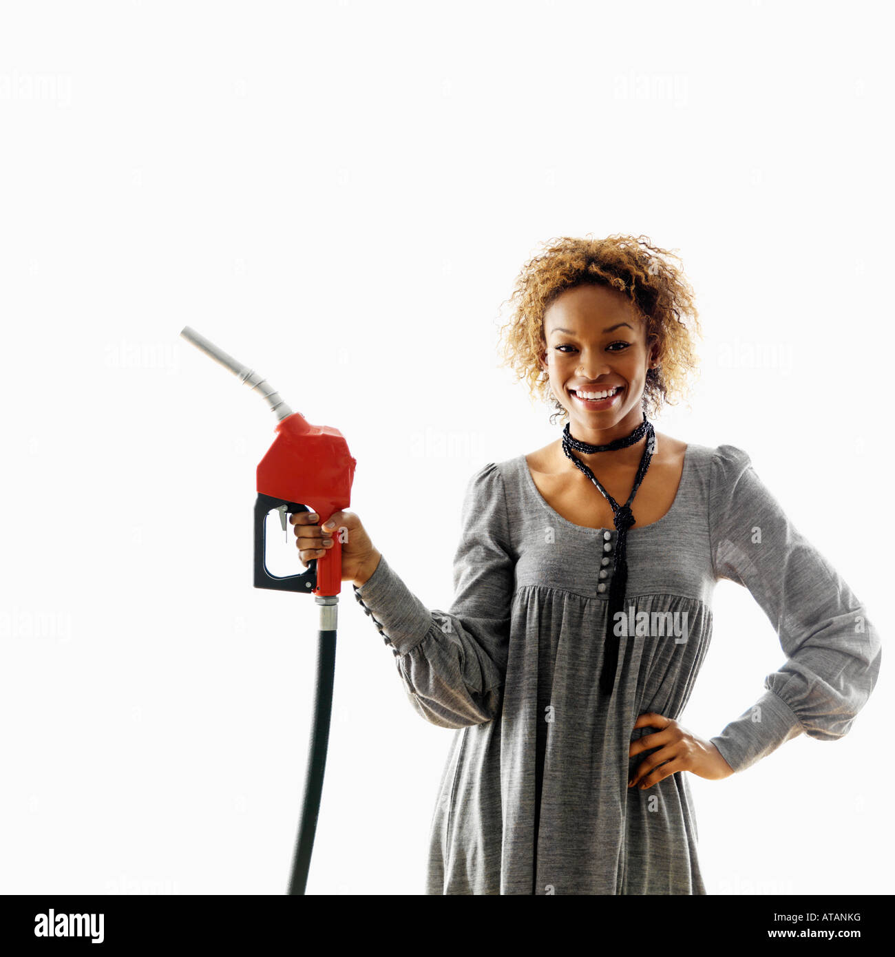 Woman holding gasoline pump nozzle smiling Stock Photo - Alamy
