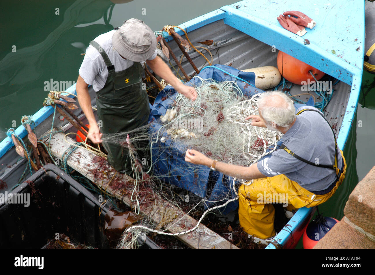 fishermen repairing and maintaining their nets Stock Photo - Alamy