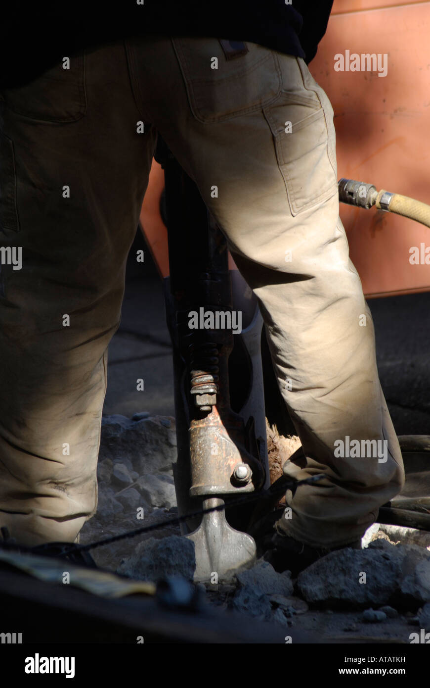 Man jackhammering cement on a sidewalk Stock Photo - Alamy