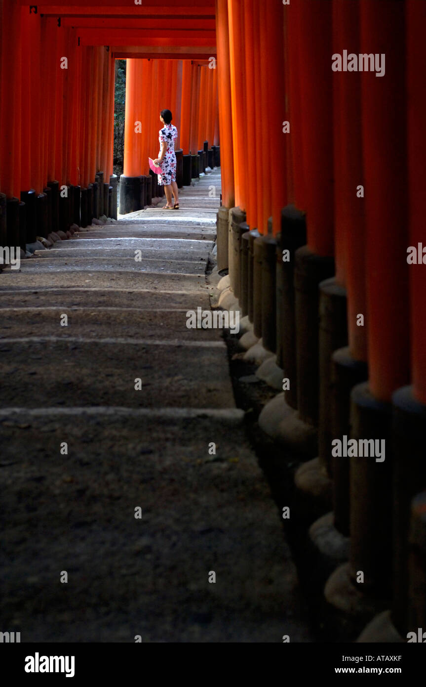 Women on a path lined with Torii gates Fushimi Inari Shrine Kyoto Japan ...