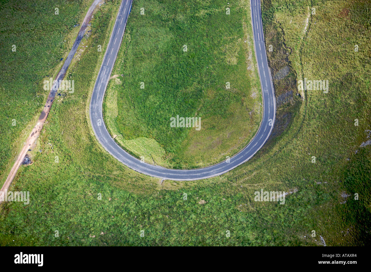 road bend field green transport hairpin bend Stock Photo - Alamy