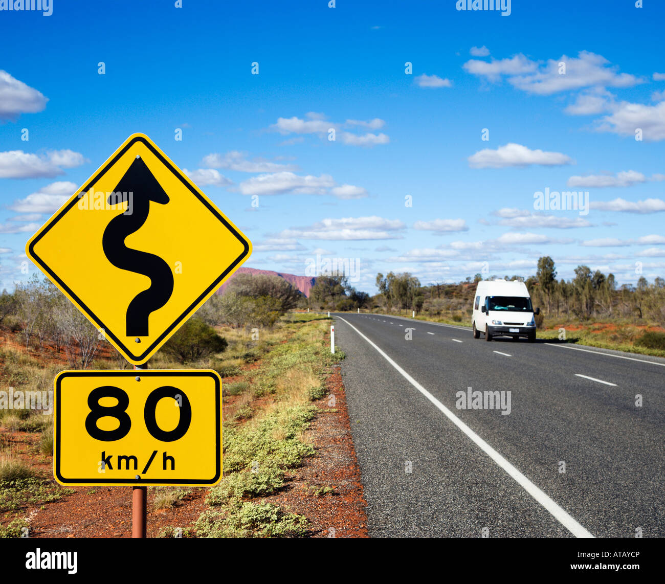 Van on asphalt two lane road in rural Australia with speed limit and ...