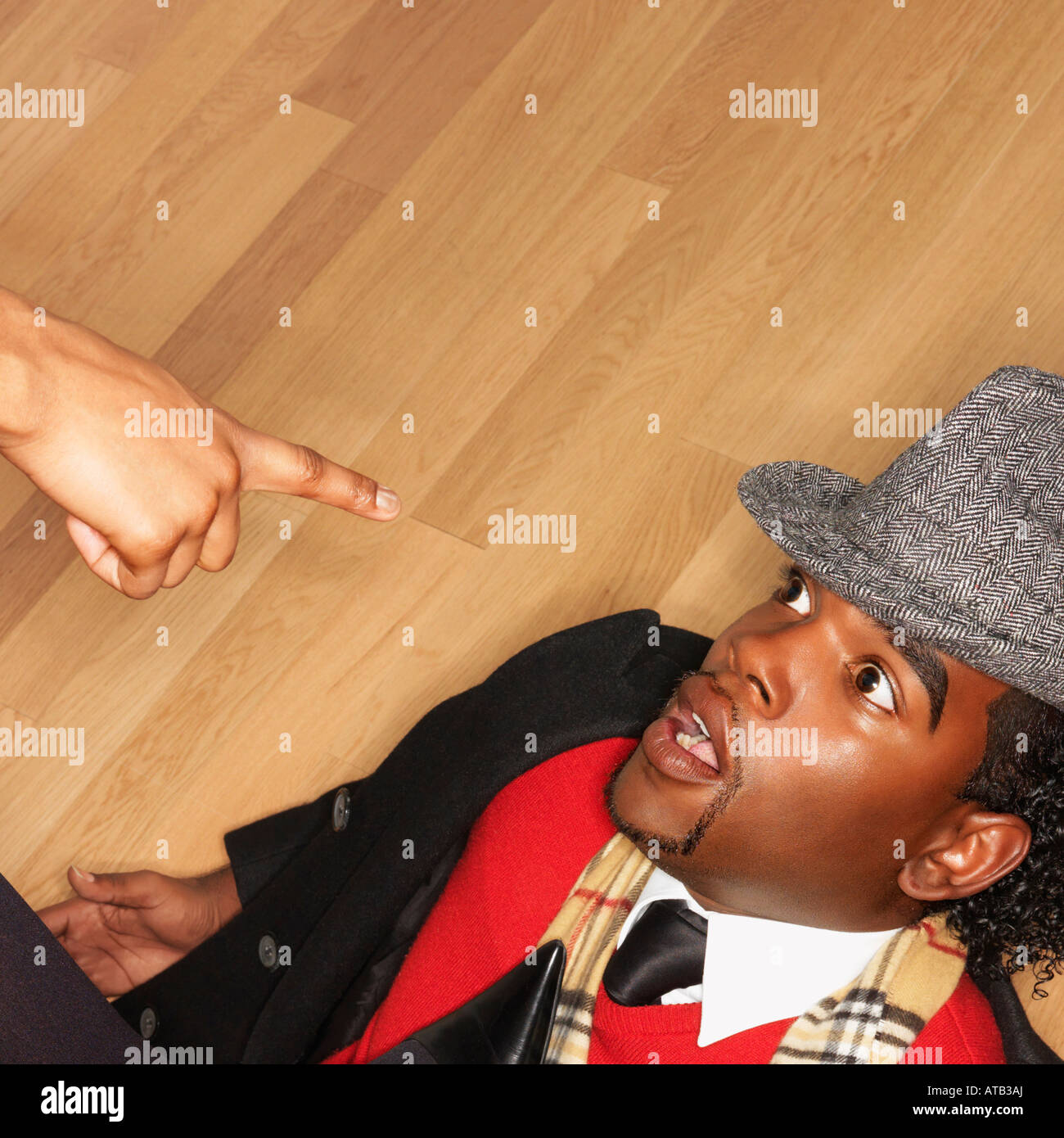 Man on back on floor with woman pointing accusingly Stock Photo - Alamy