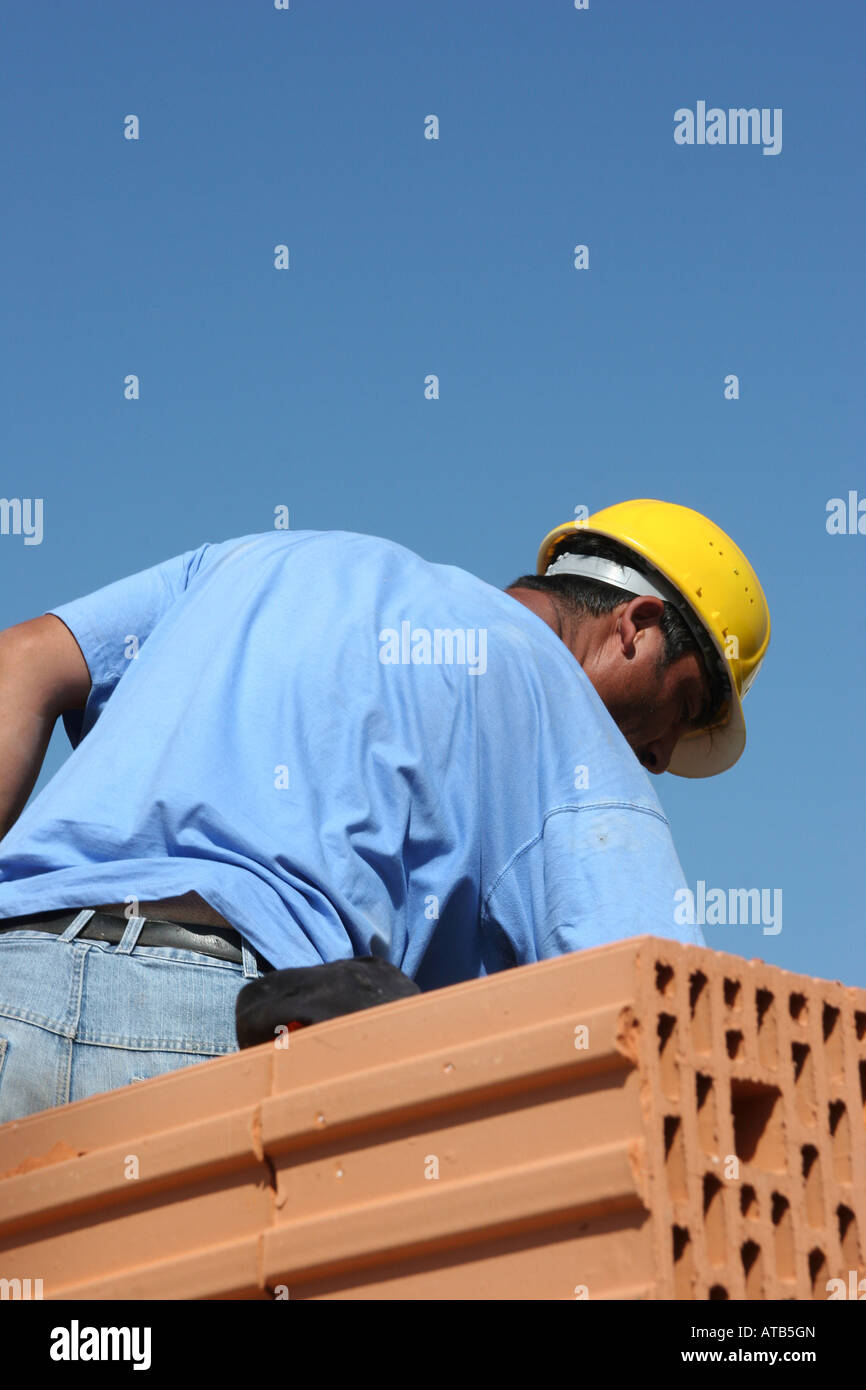 Workers building up a brick wall Stock Photo - Alamy