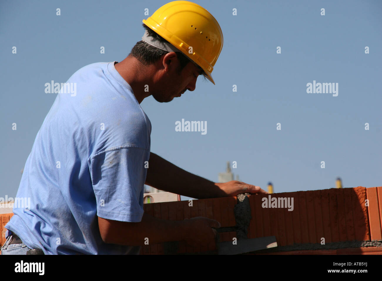 Workers building up a brick wall Stock Photo - Alamy