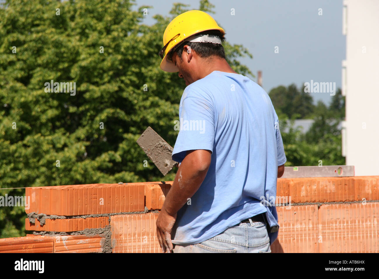 Workers building up a brick wall Stock Photo - Alamy
