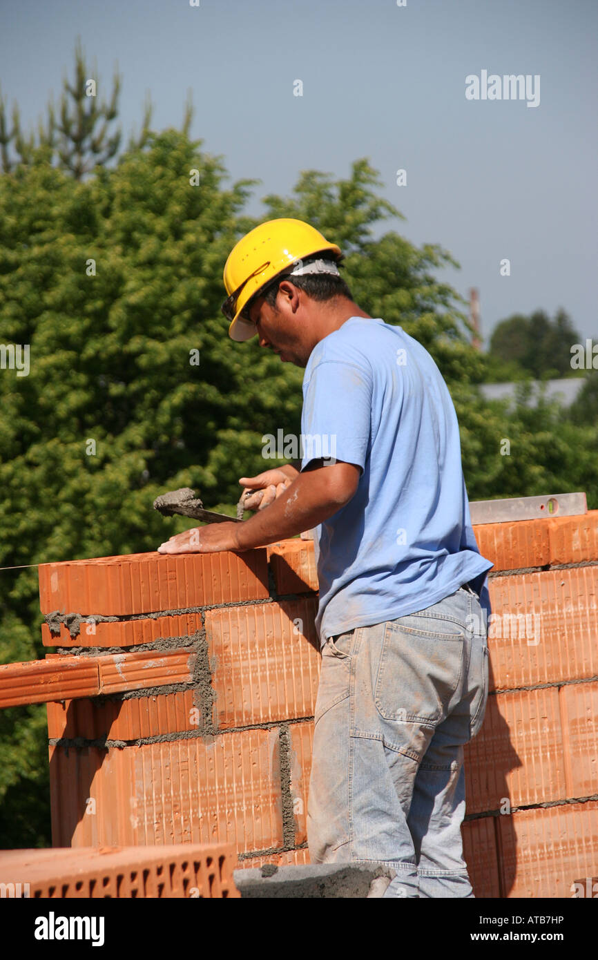 Workers building up a brick wall Stock Photo - Alamy